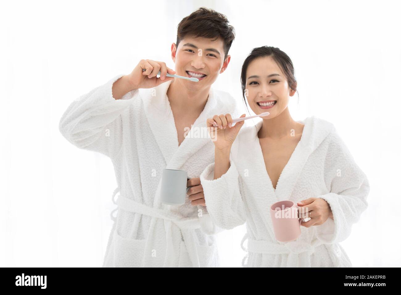 Young Chinese couple brushing teeth at home Stock Photo - Alamy