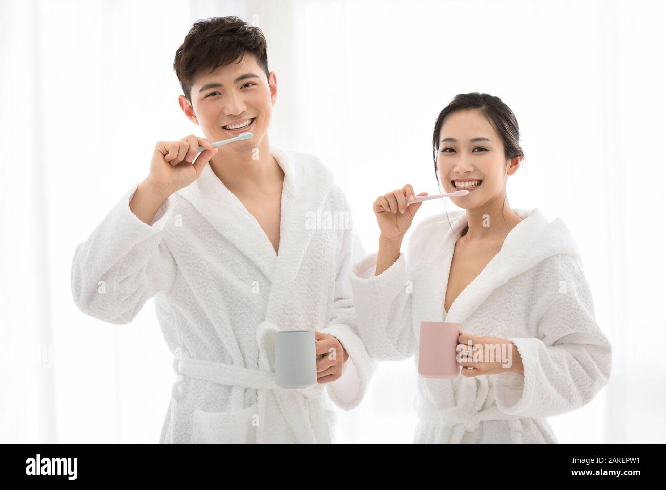 Young Chinese couple brushing teeth at home Stock Photo - Alamy
