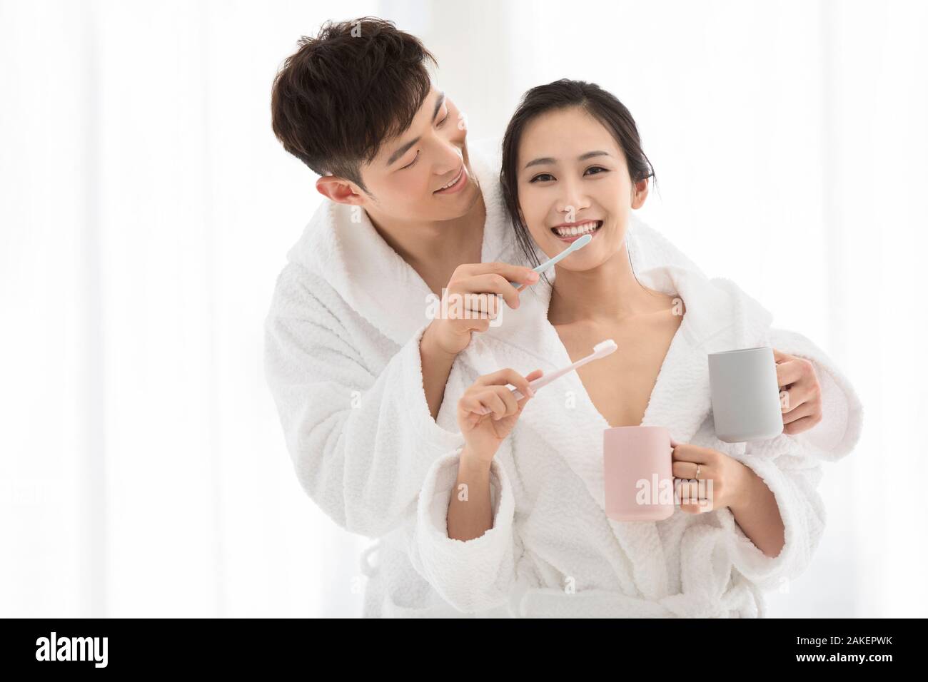 Young Chinese couple brushing teeth at home Stock Photo - Alamy
