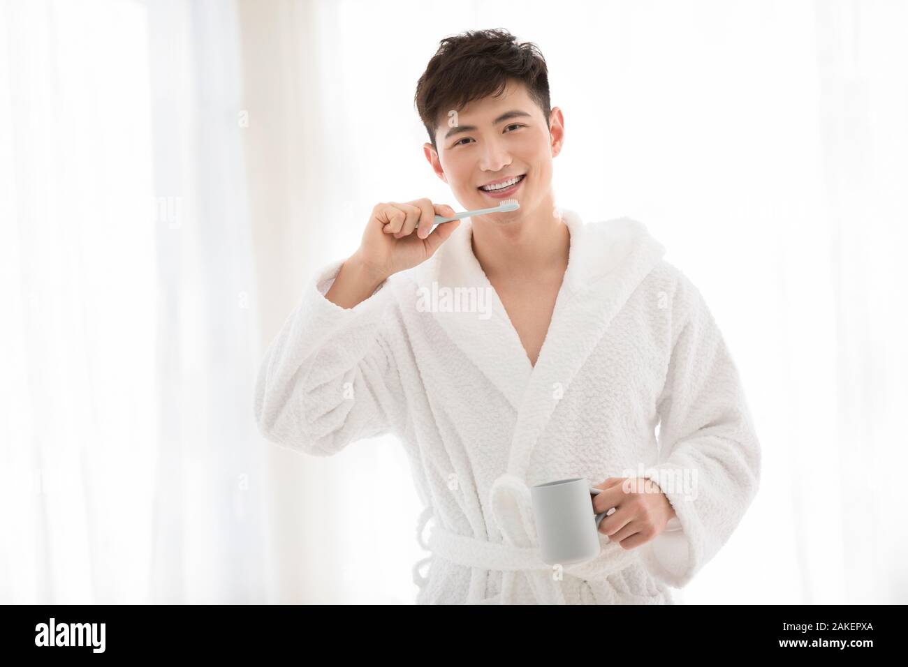 Young Chinese man brushing teeth Stock Photo - Alamy