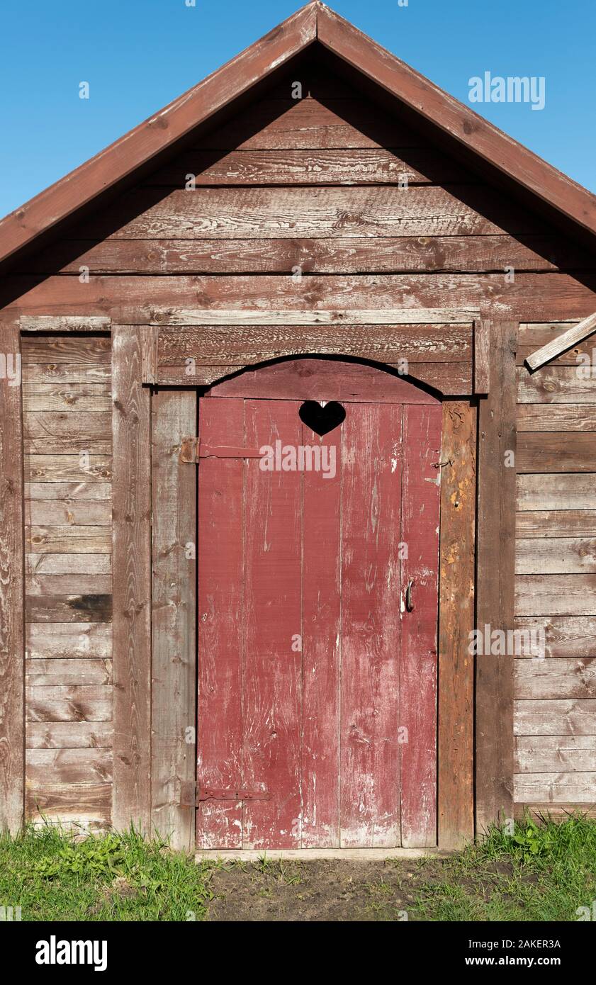 Red toilet with heart in countryside Stock Photo - Alamy