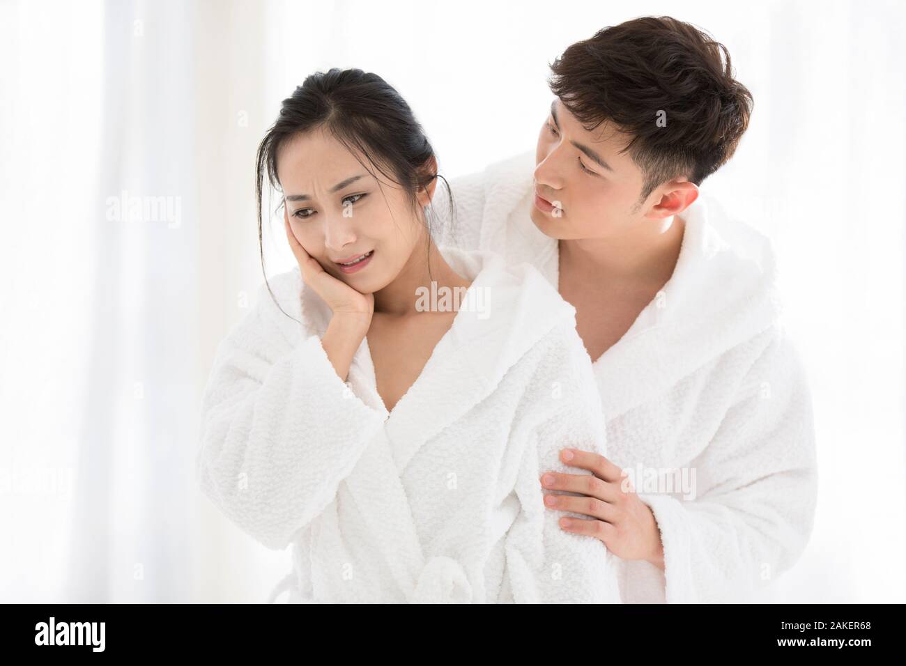 Young Chinese woman suffering from toothache Stock Photo - Alamy