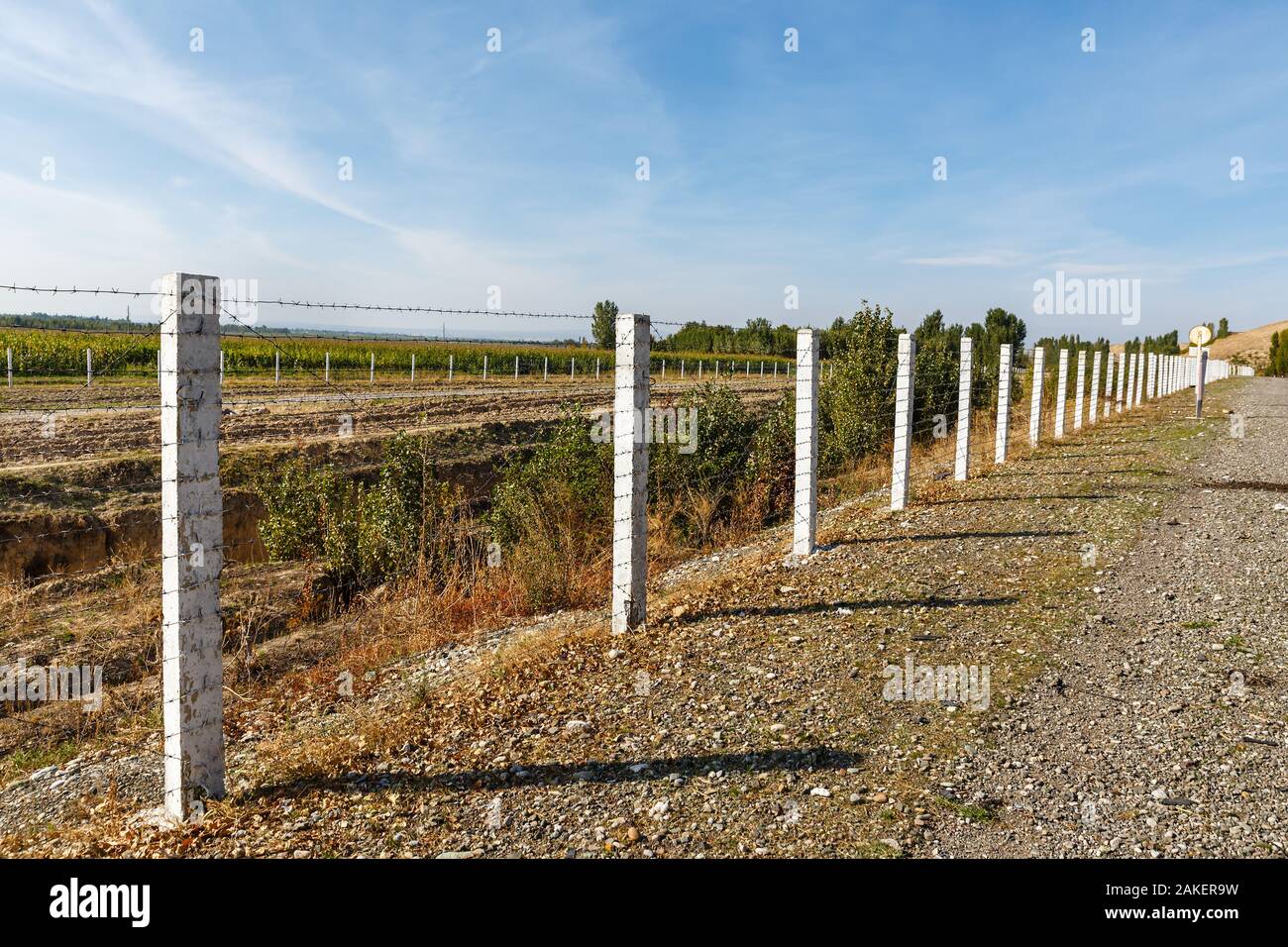 barbed wire fence, state border between Kyrgyzstan and Uzbekistan Stock ...