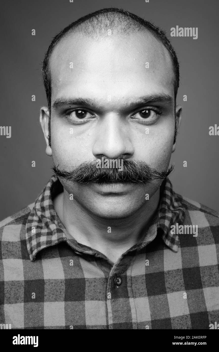 Indian man with mustache against gray background Stock Photo - Alamy