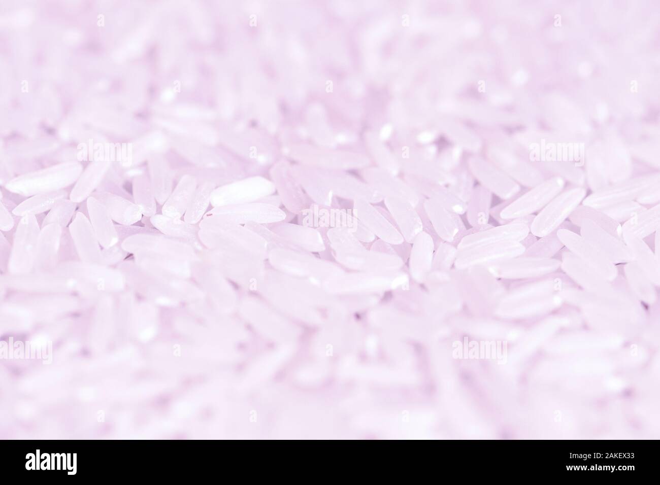 White rice grains scattered on a wooden surface close up. Food ...