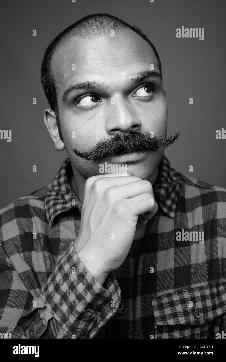 Indian man with mustache against gray background Stock Photo - Alamy