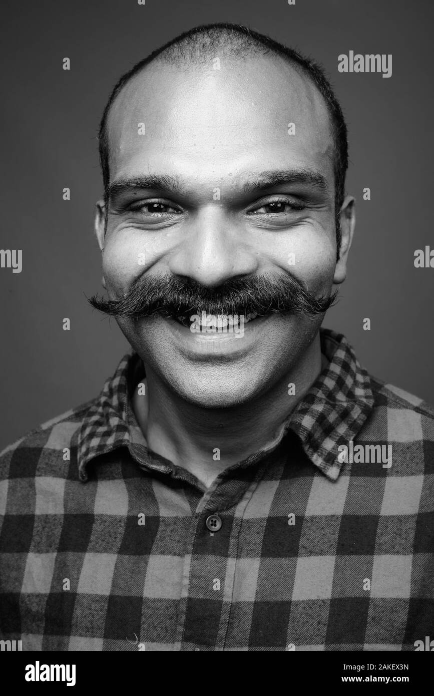 Indian man with mustache against gray background Stock Photo - Alamy