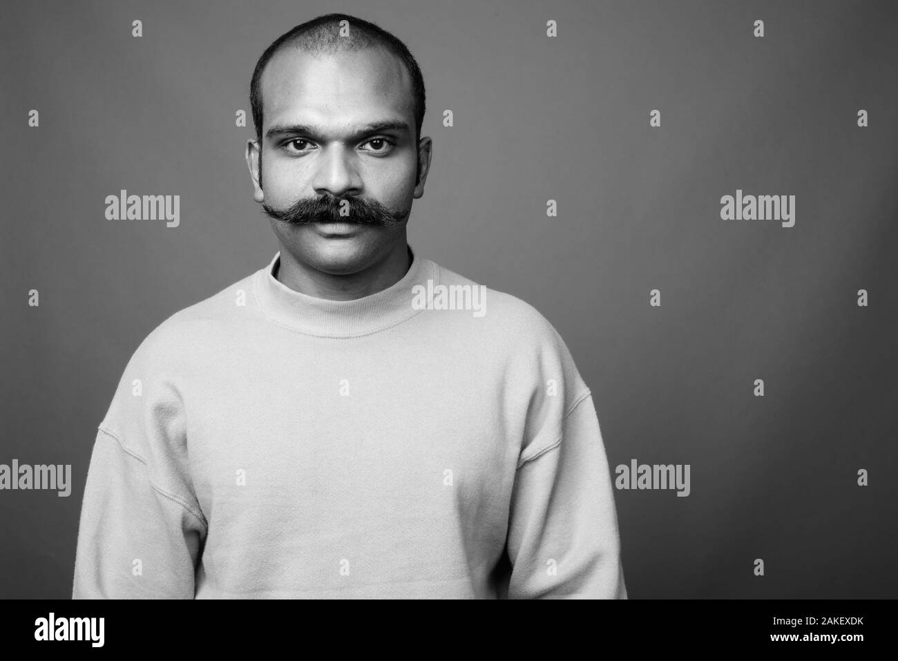 Indian man with mustache against gray background Stock Photo - Alamy