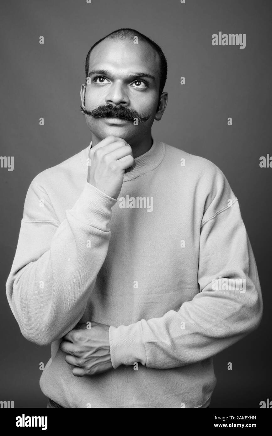 Indian man with mustache against gray background Stock Photo - Alamy