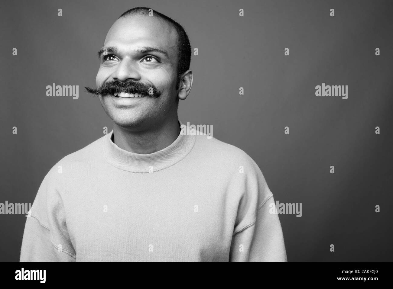 Indian man with mustache against gray background Stock Photo - Alamy
