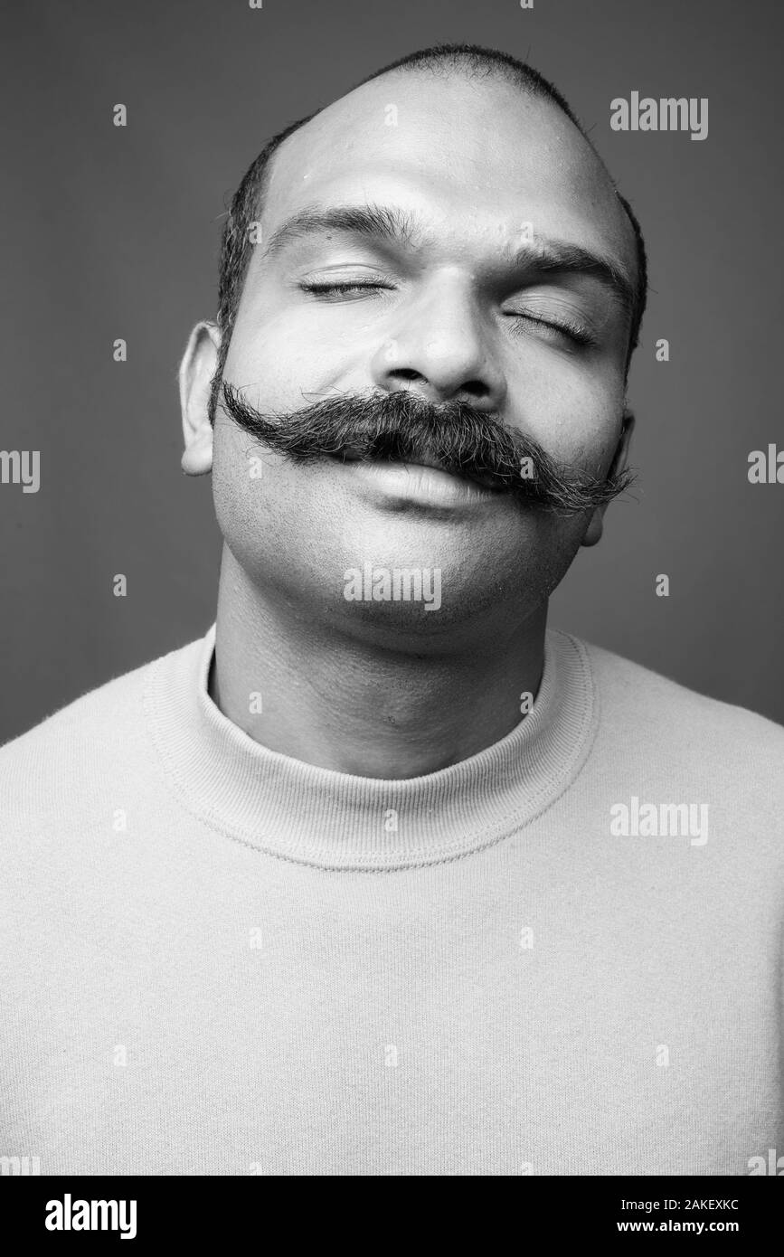 Indian man with mustache against gray background Stock Photo - Alamy