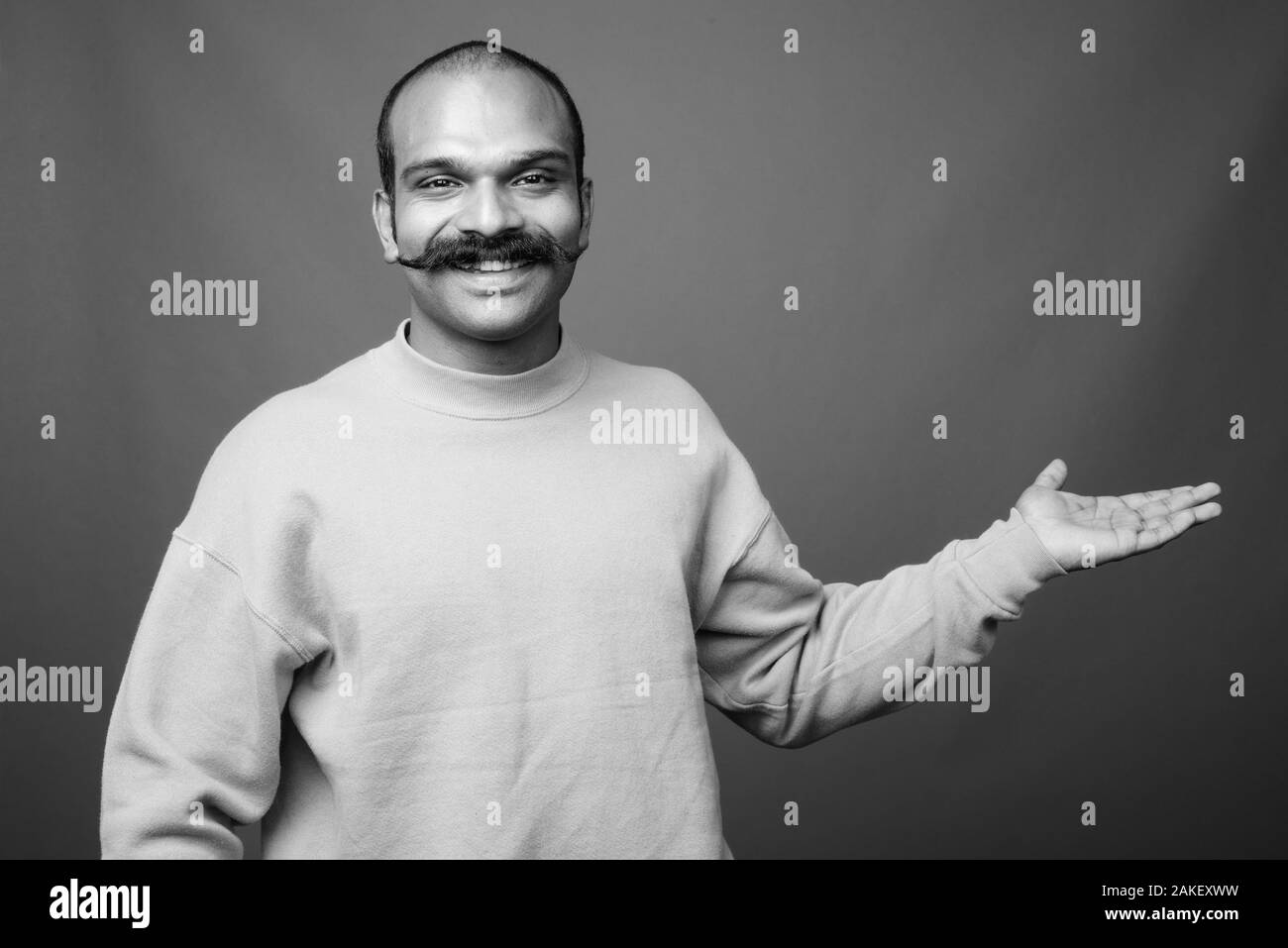 Indian man with mustache against gray background Stock Photo - Alamy