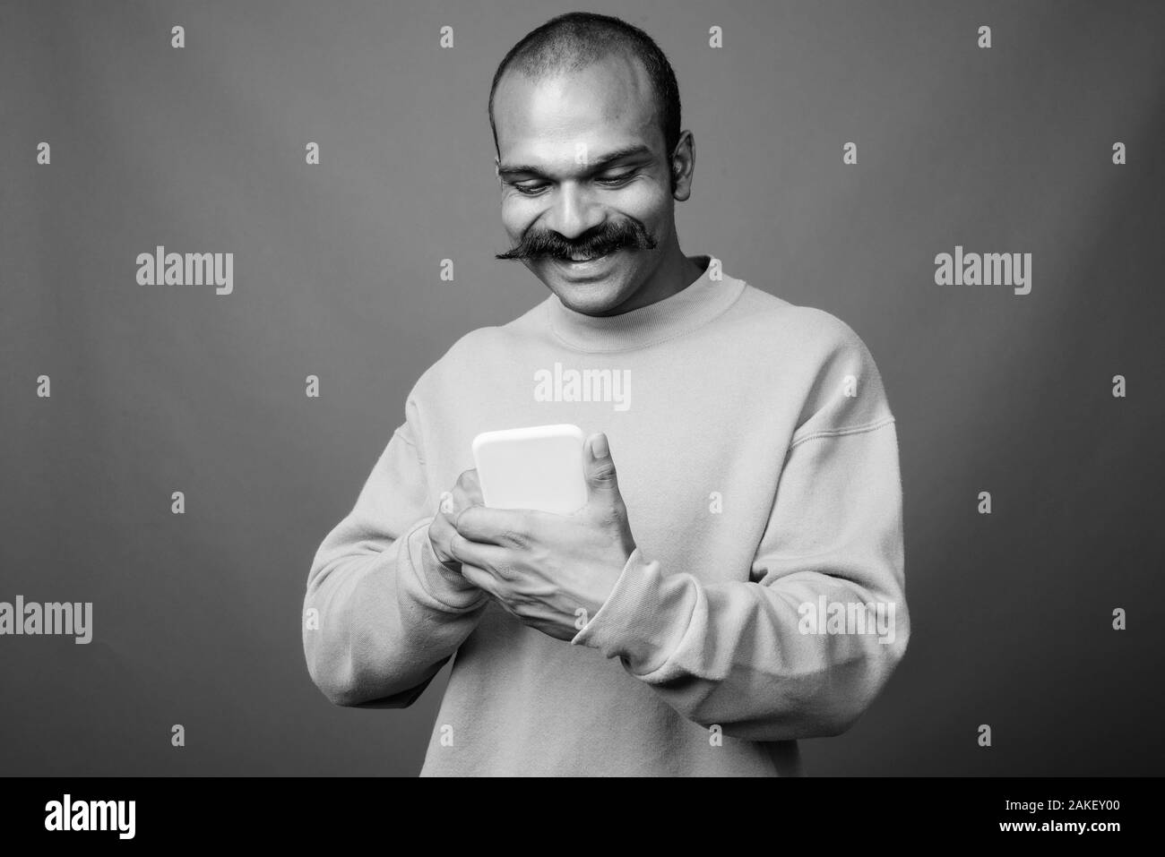 Indian man with mustache against gray background Stock Photo - Alamy
