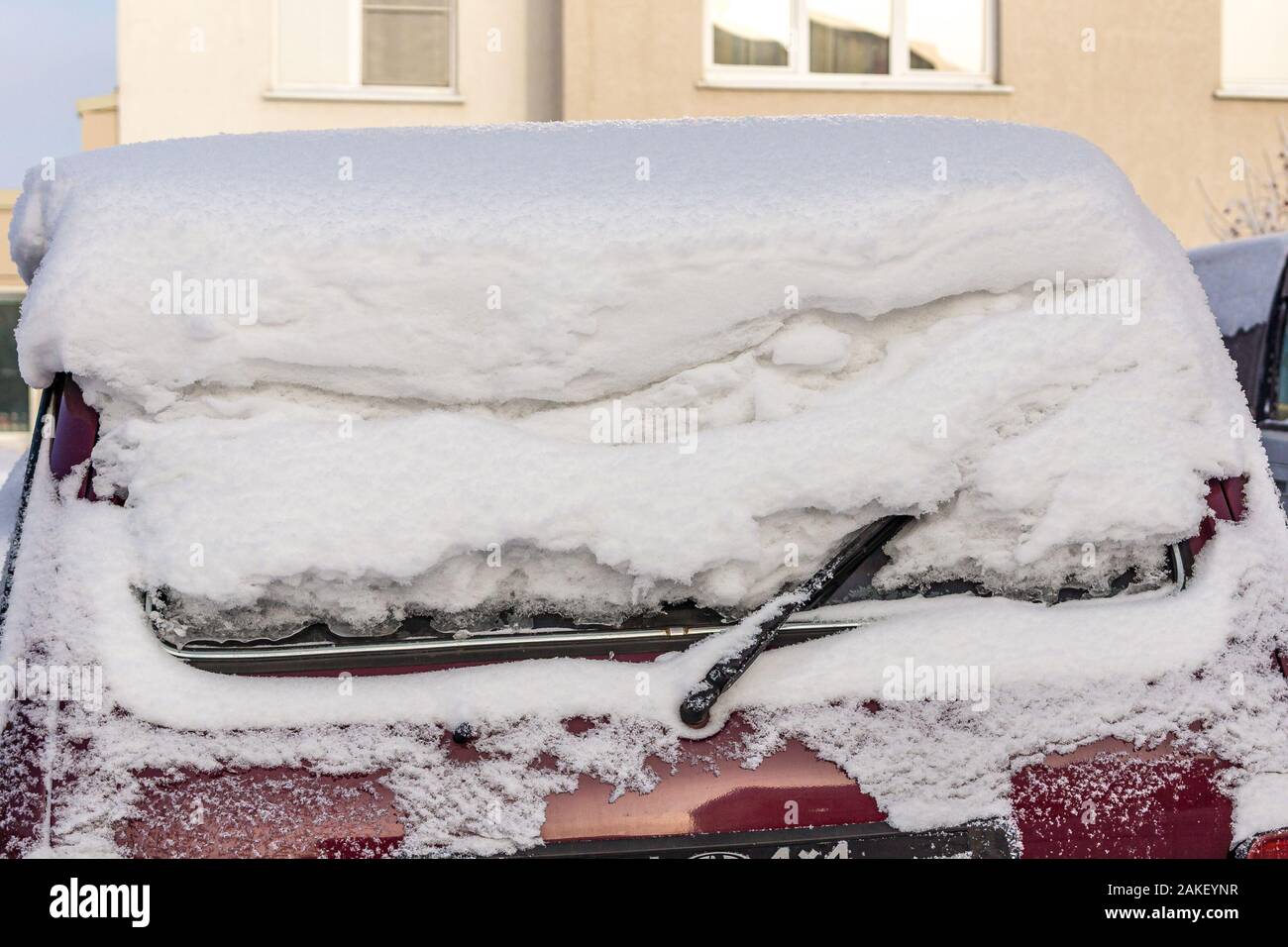 car rear window covered with a large layer of snow Stock Photo - Alamy