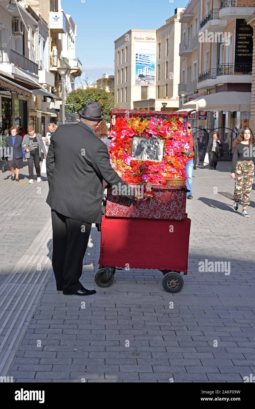 Man playing a hand wound musical instrument called "Laterna" in the ...