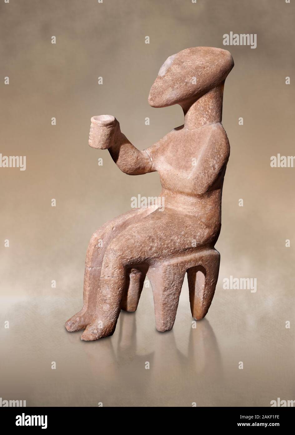 Rare male Cycladic statue of a seated warrior or hunter holding a cup ...