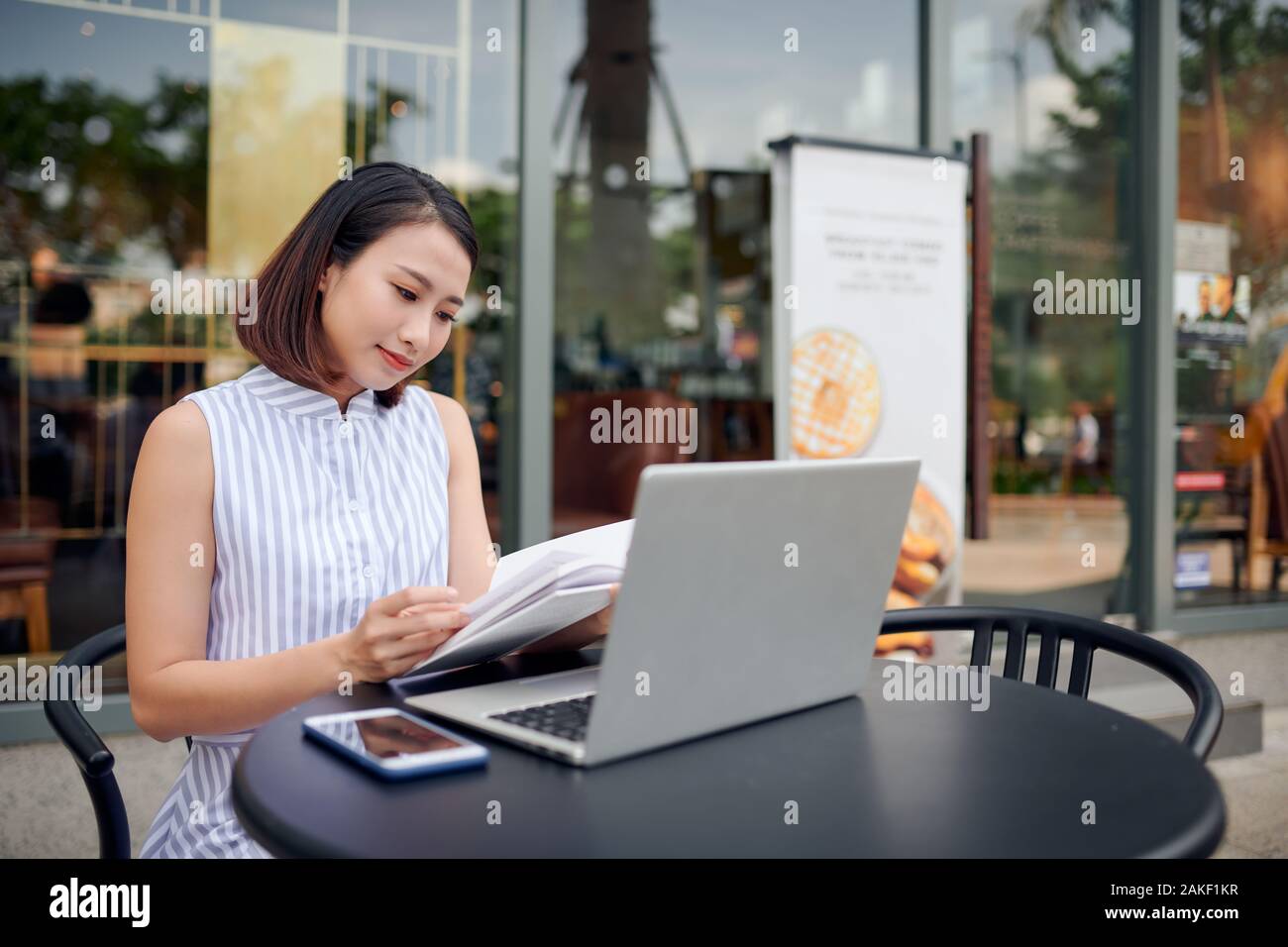 Beautiful girl reading a book in coffee shop Stock Photo - Alamy
