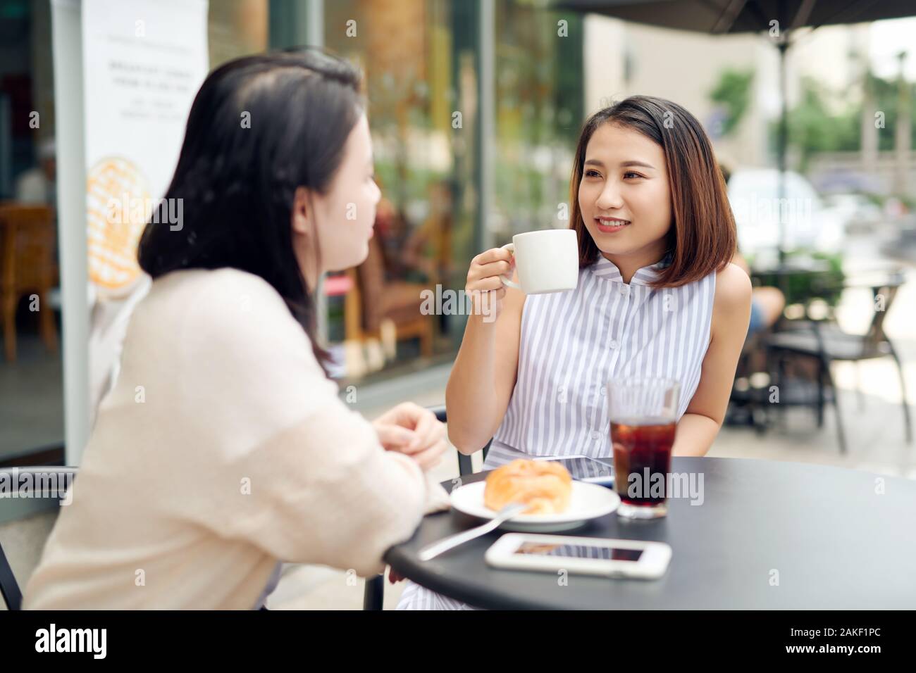 Women gossiping coffee hi-res stock photography and images - Alamy