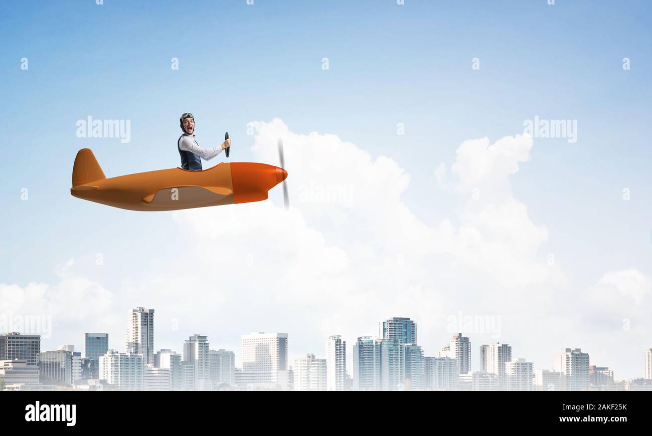 Scared pilot with open mouth in airplane Stock Photo - Alamy