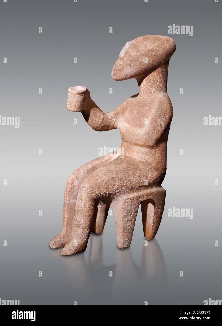 Rare male Cycladic statue of a seated warrior or hunter holding a cup ...