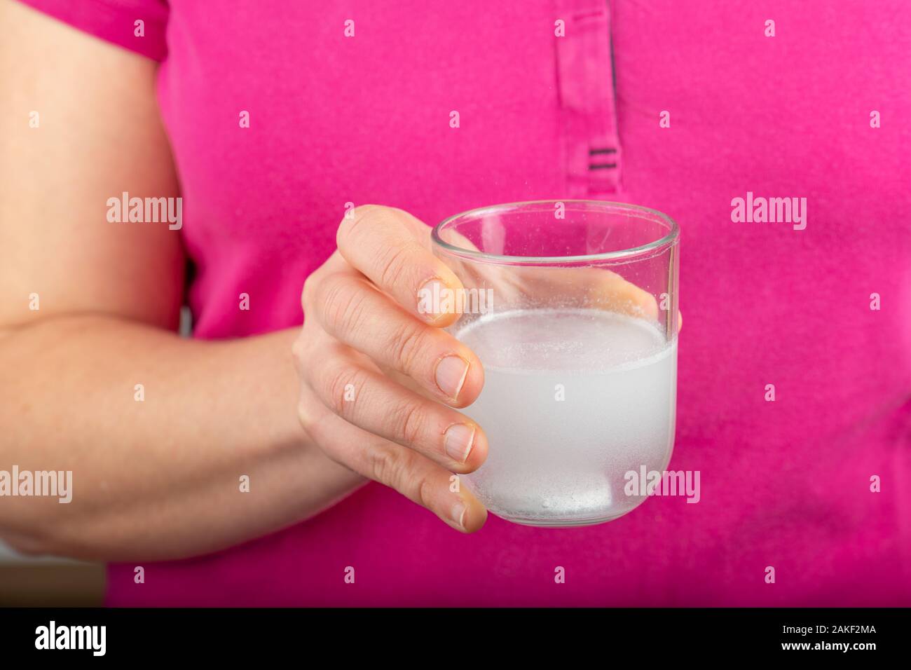 Woman taking effervescent tablet hi-res stock photography and images ...
