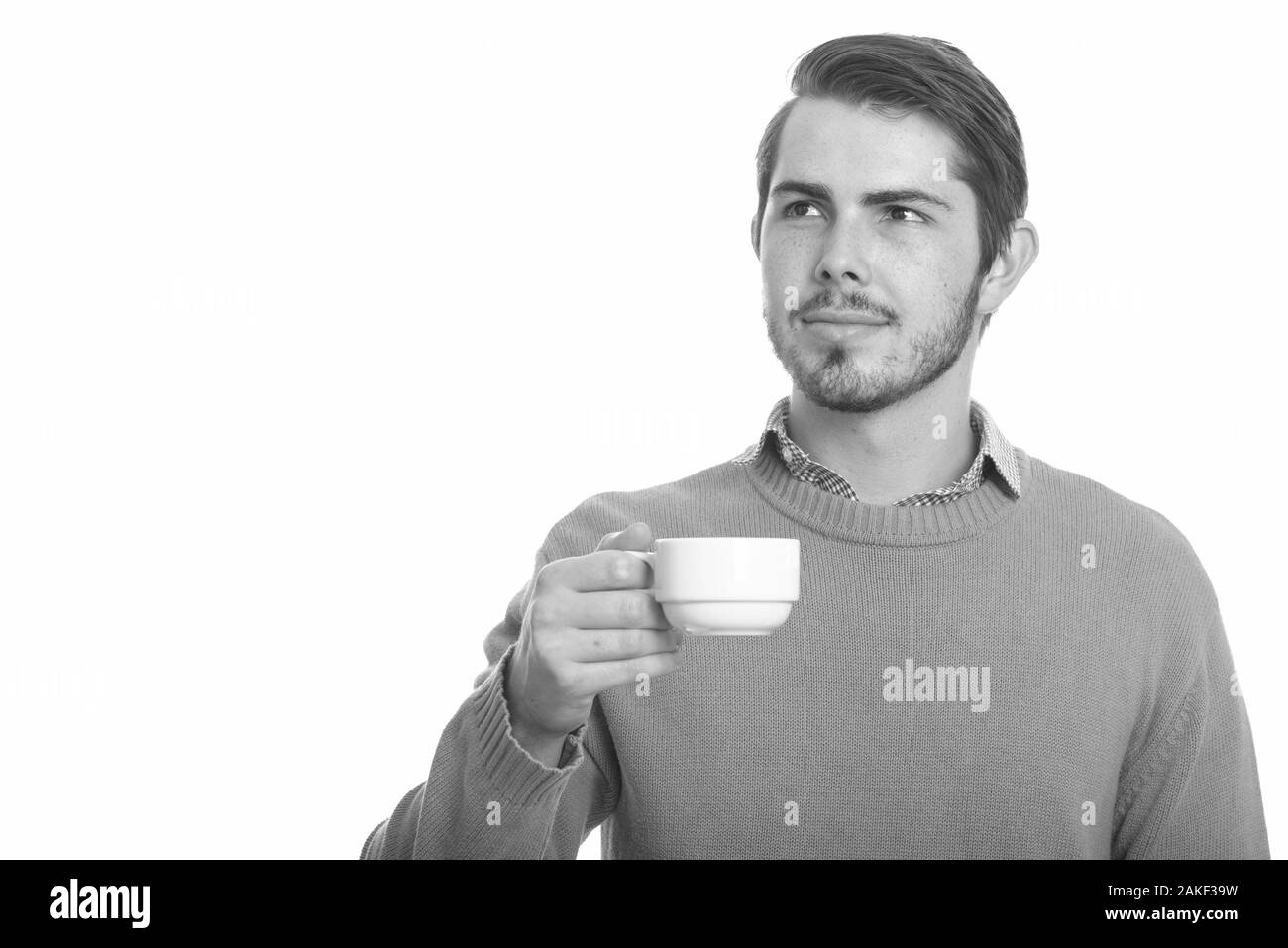 Thoughtful young man drinking Black and White Stock Photos & Images - Alamy