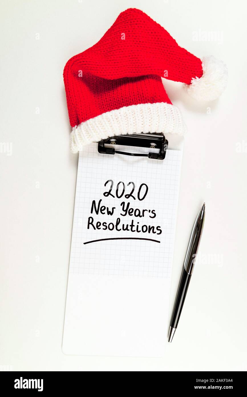 New year resolutions 2020 on desk. 2020 goals list with notebook, santa ...