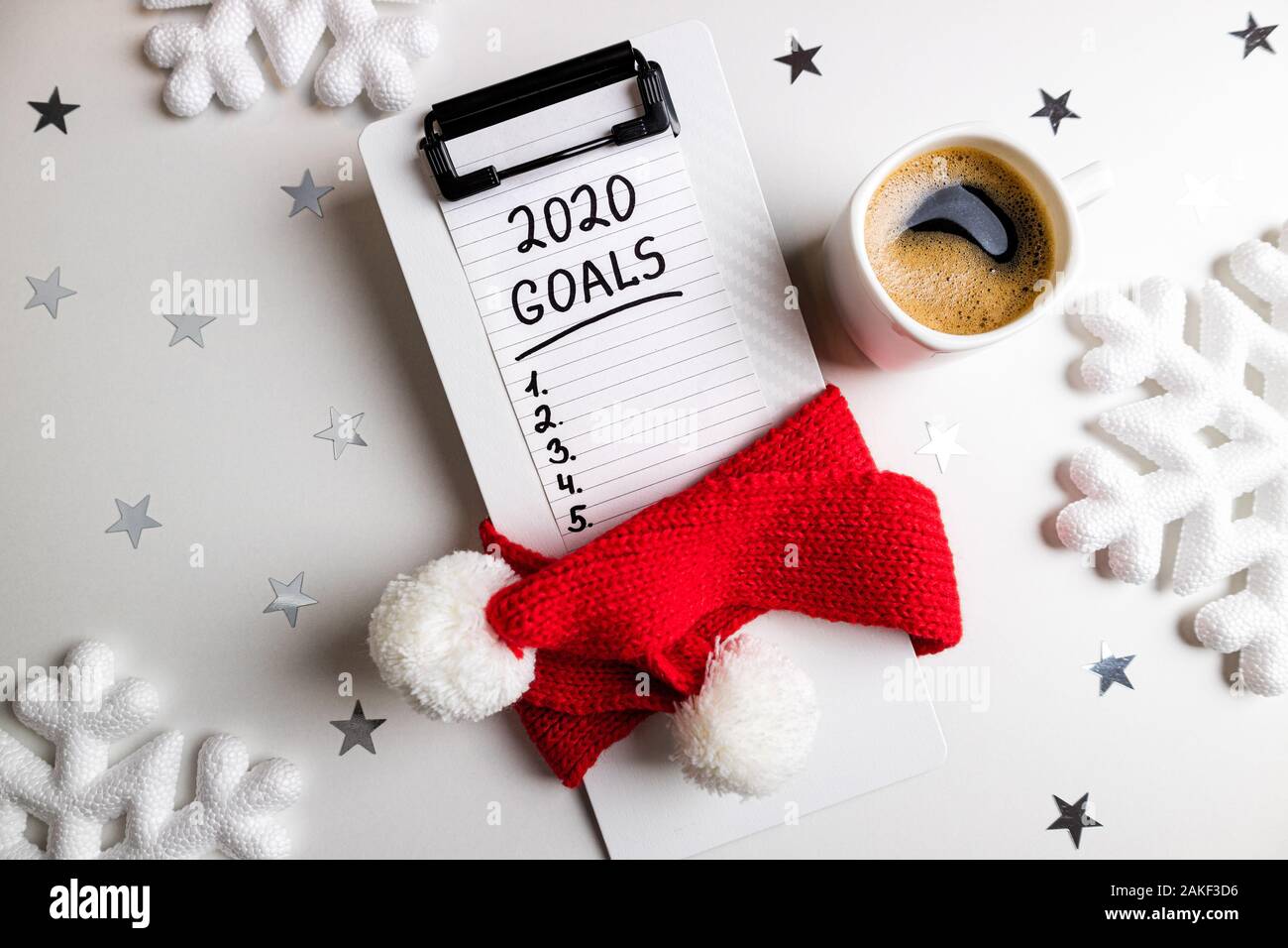 New year goals 2020 on desk. 2020 goals list with notebook, cup of ...