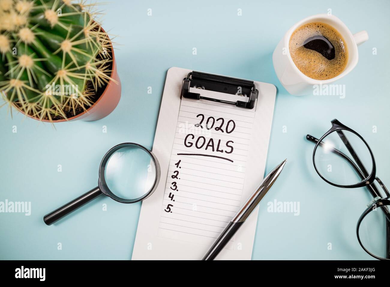 New year goals 2020 on desk. 2020 resolutions with notebook, coffee cup ...