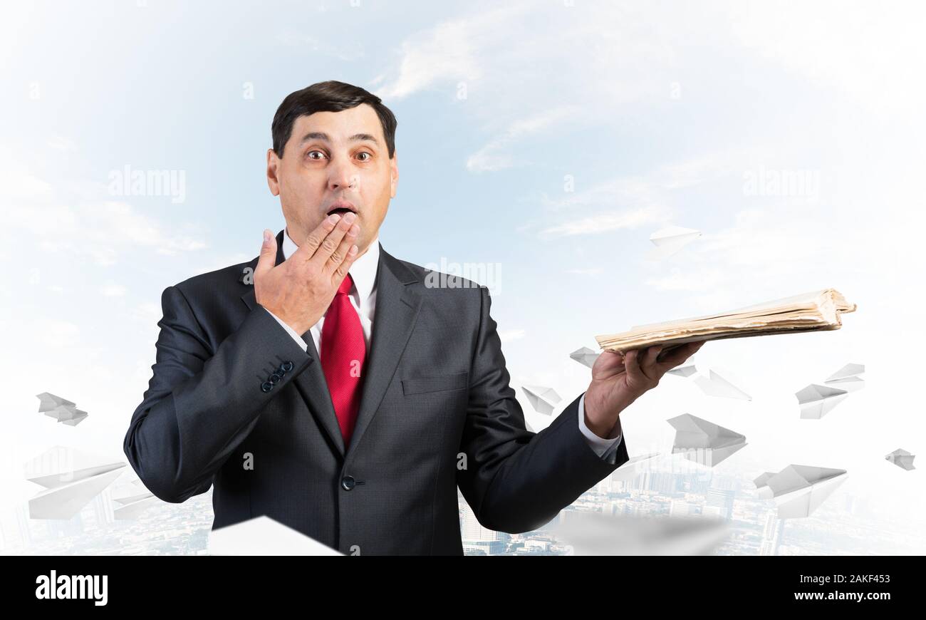 Embarrassed businessman covering mouth with hand Stock Photo - Alamy