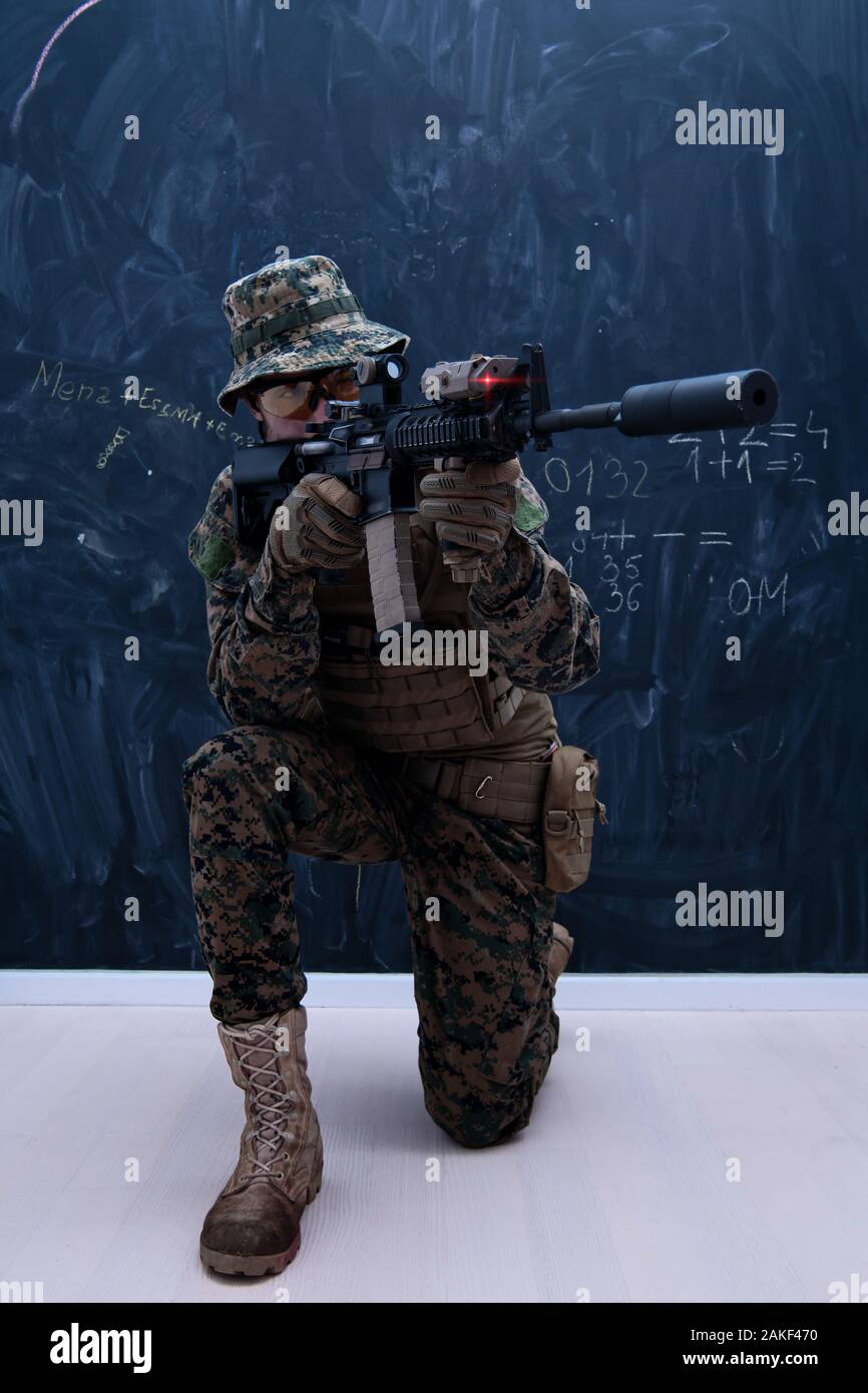 modern warfare american marines soldier in action while sneaking and aiming sniper riffle on ...