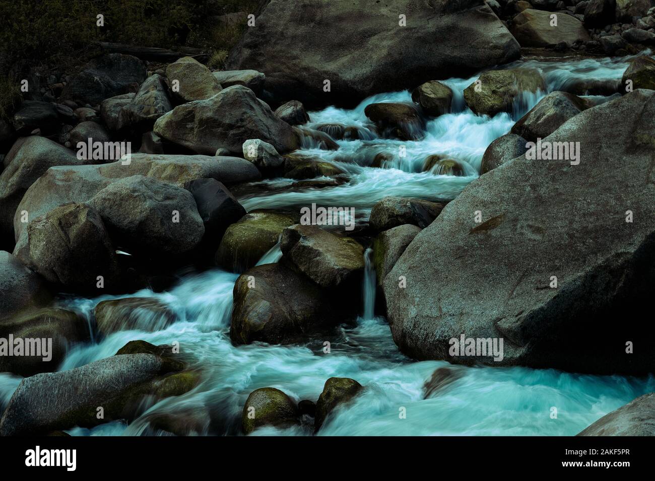 long exposure photograph of water flowing slowly through the rocks ...