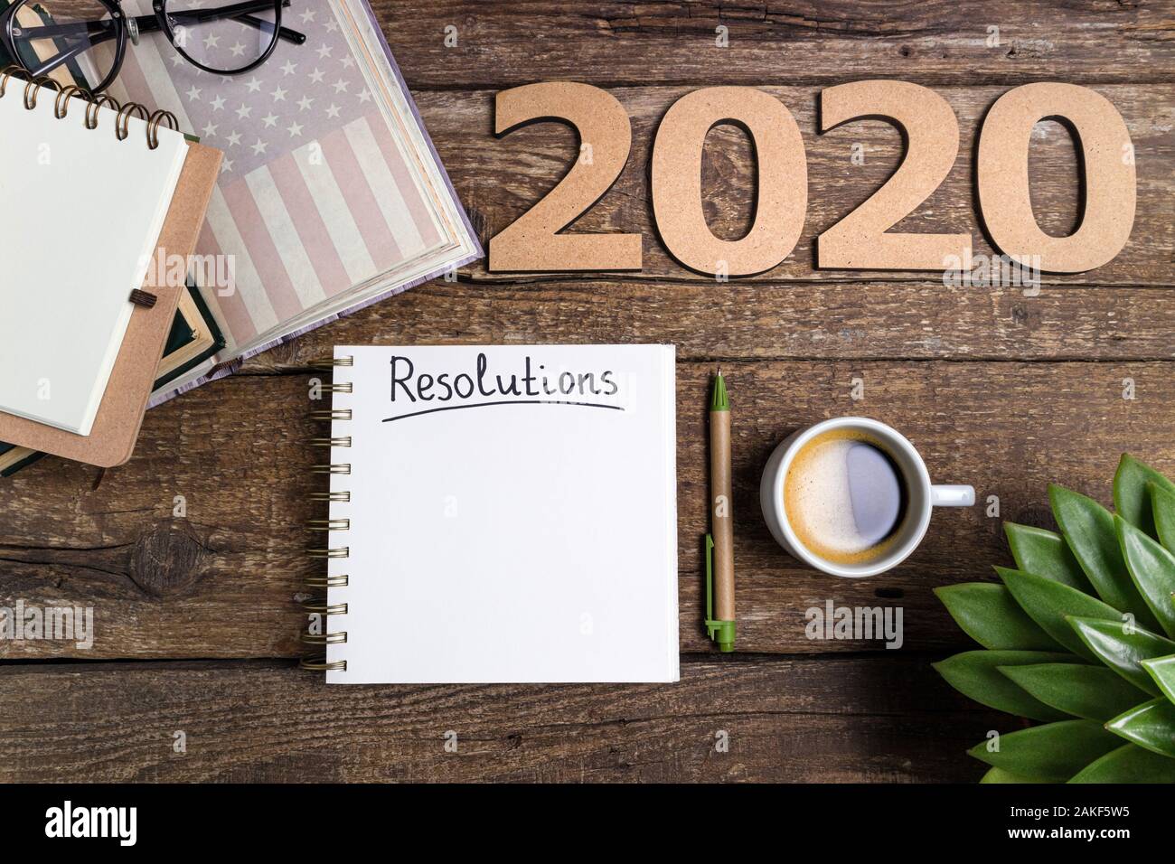 New year resolutions 2020 on desk. 2020 goals list with old book ...