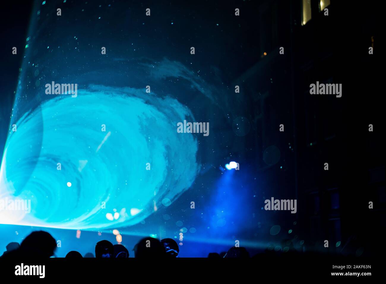 Abstract colored laser light with tunnel effects smoke during a rain ...