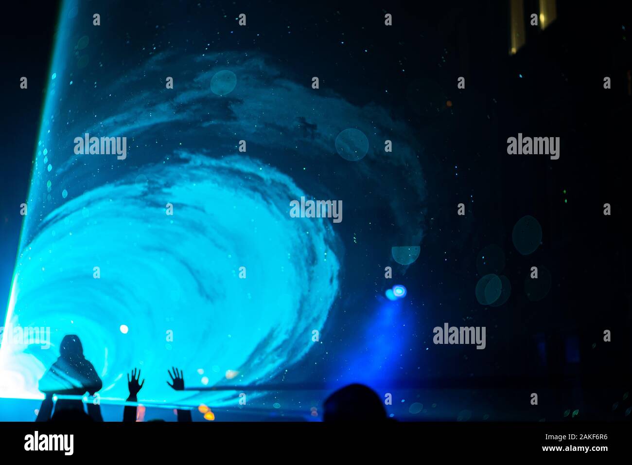 Abstract colored laser light with tunnel effects smoke during a rain ...