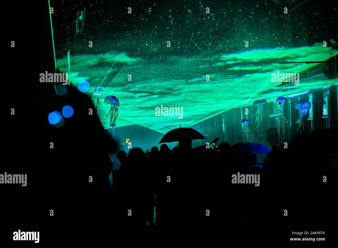 Abstract colored laser light with tunnel effects smoke during a rain ...