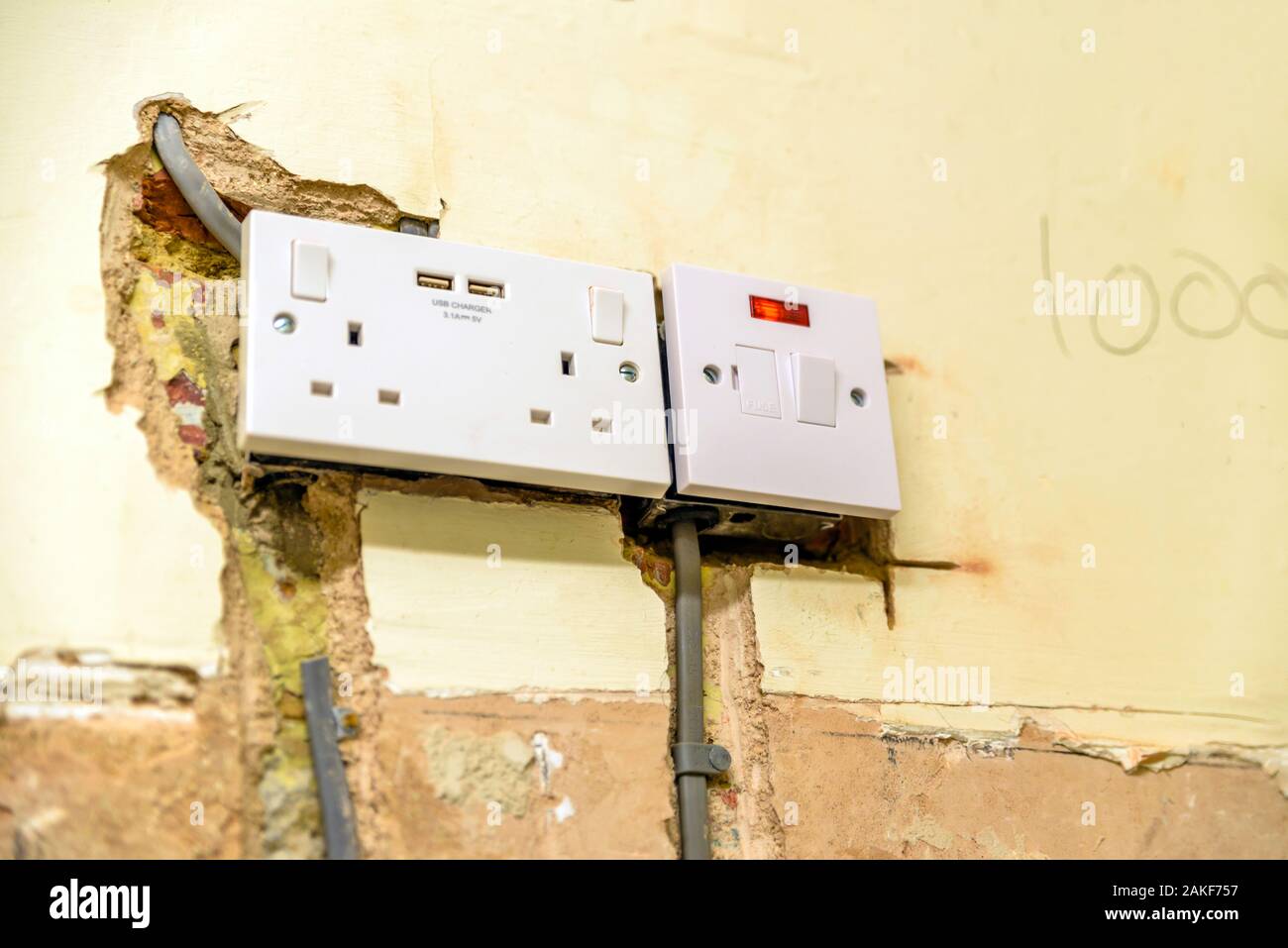 electric socket in a wall during renovation in england uk Stock Photo ...