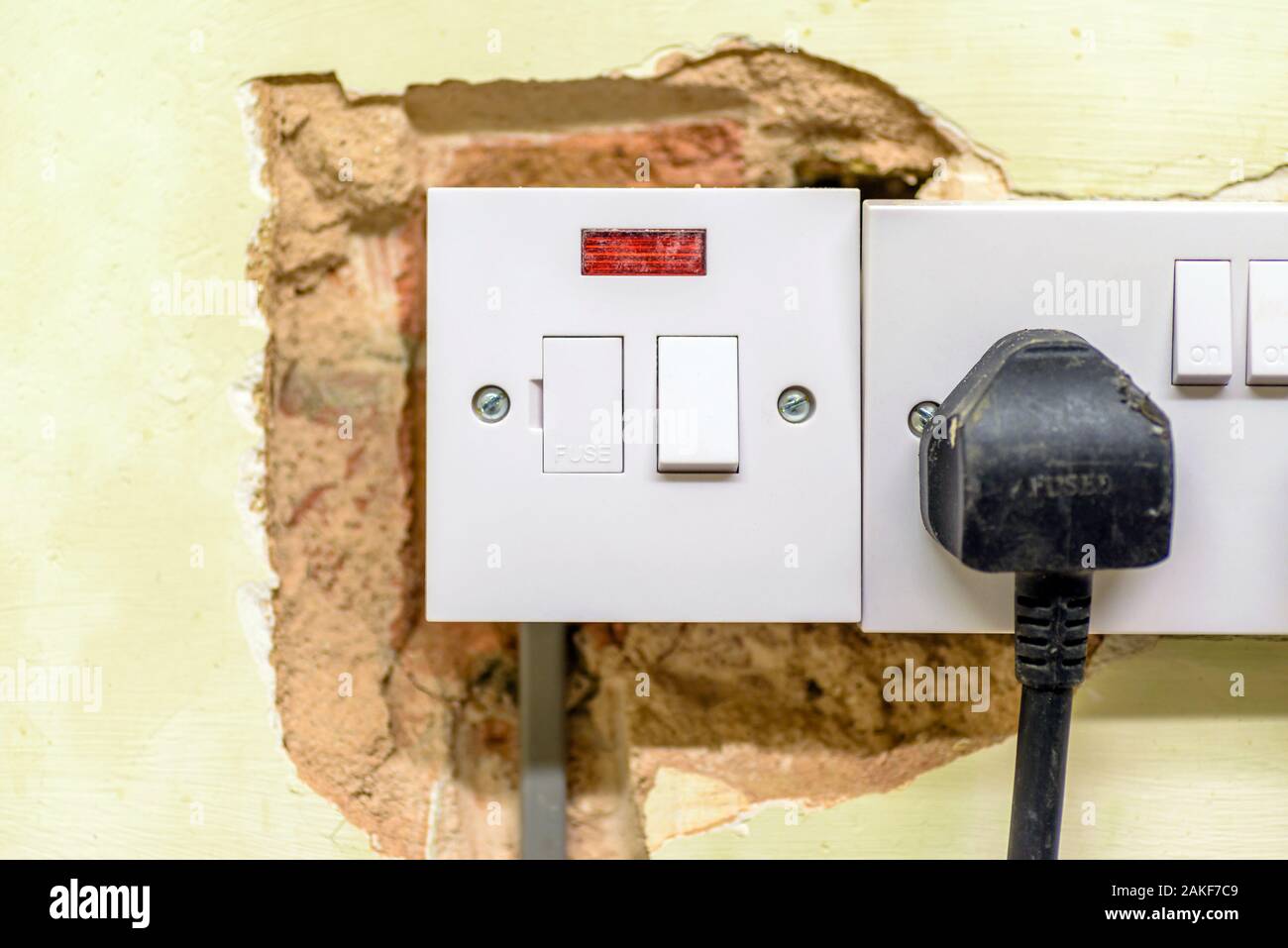 electric socket in a wall during renovation in england uk Stock Photo ...
