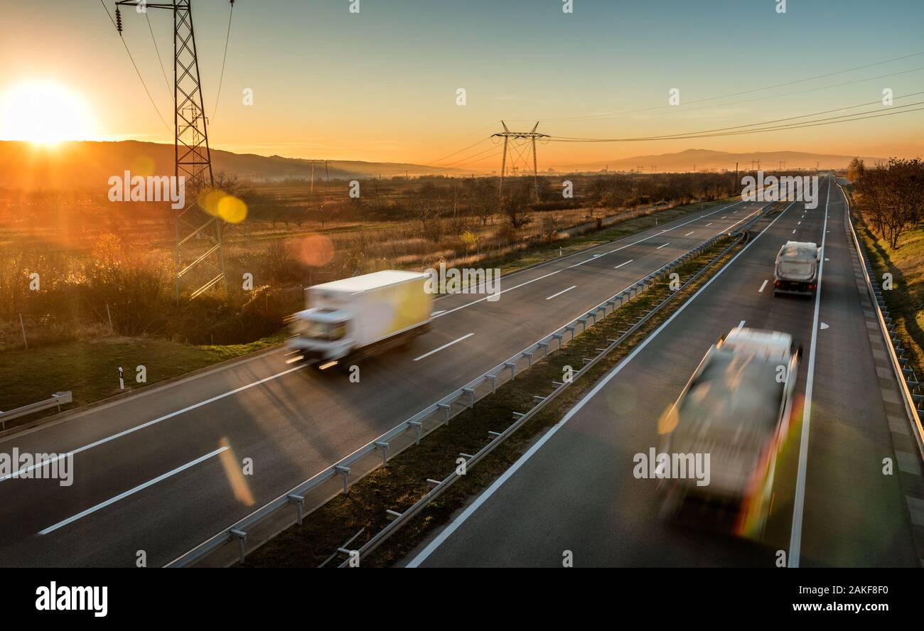 Traffic in high speed on a highway through rural landscape. Fast ...