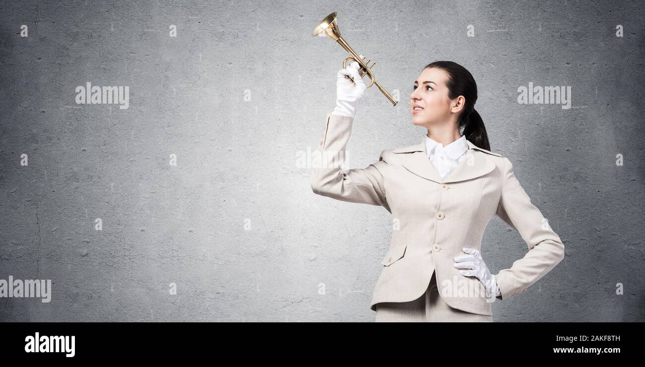 Beautiful woman playing trumpet brass Stock Photo - Alamy