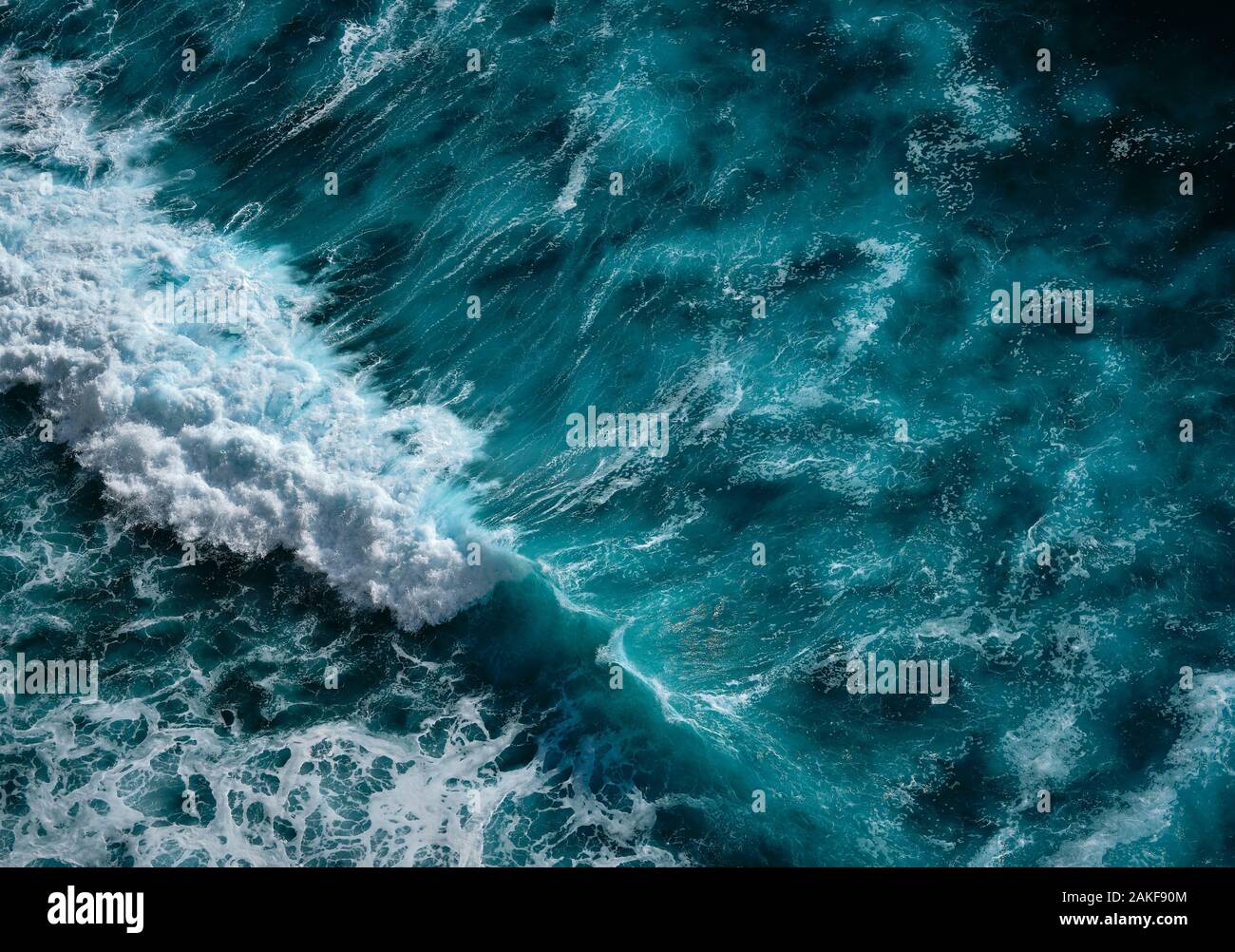 Aerial view to seething waves with foam. Blue water background ...