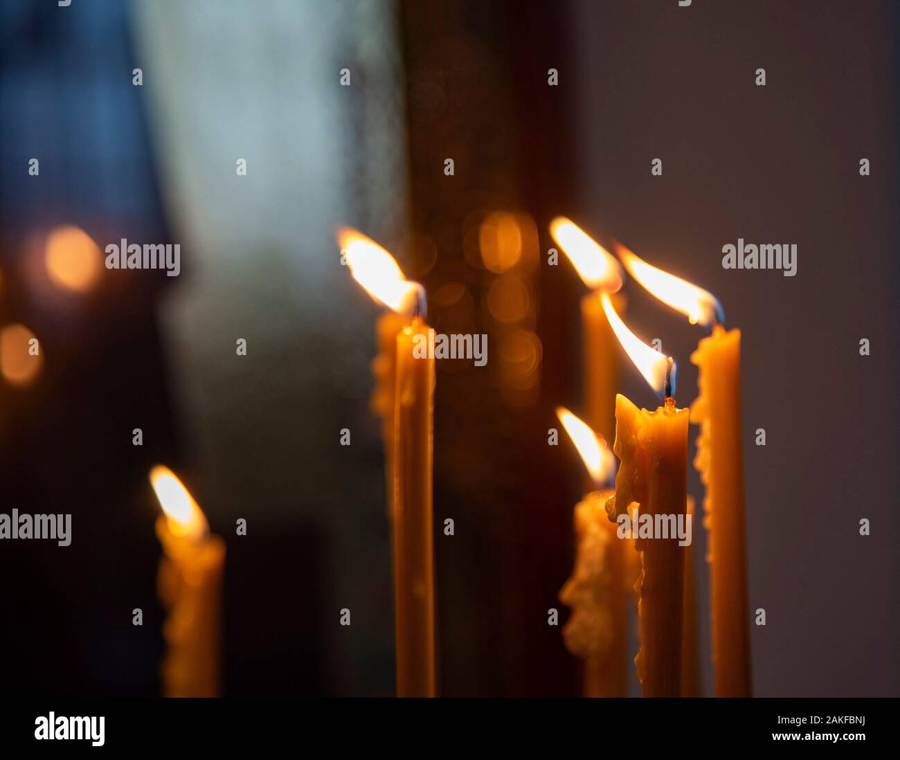 Burning in the dim light of candles in the Church Stock Photo - Alamy