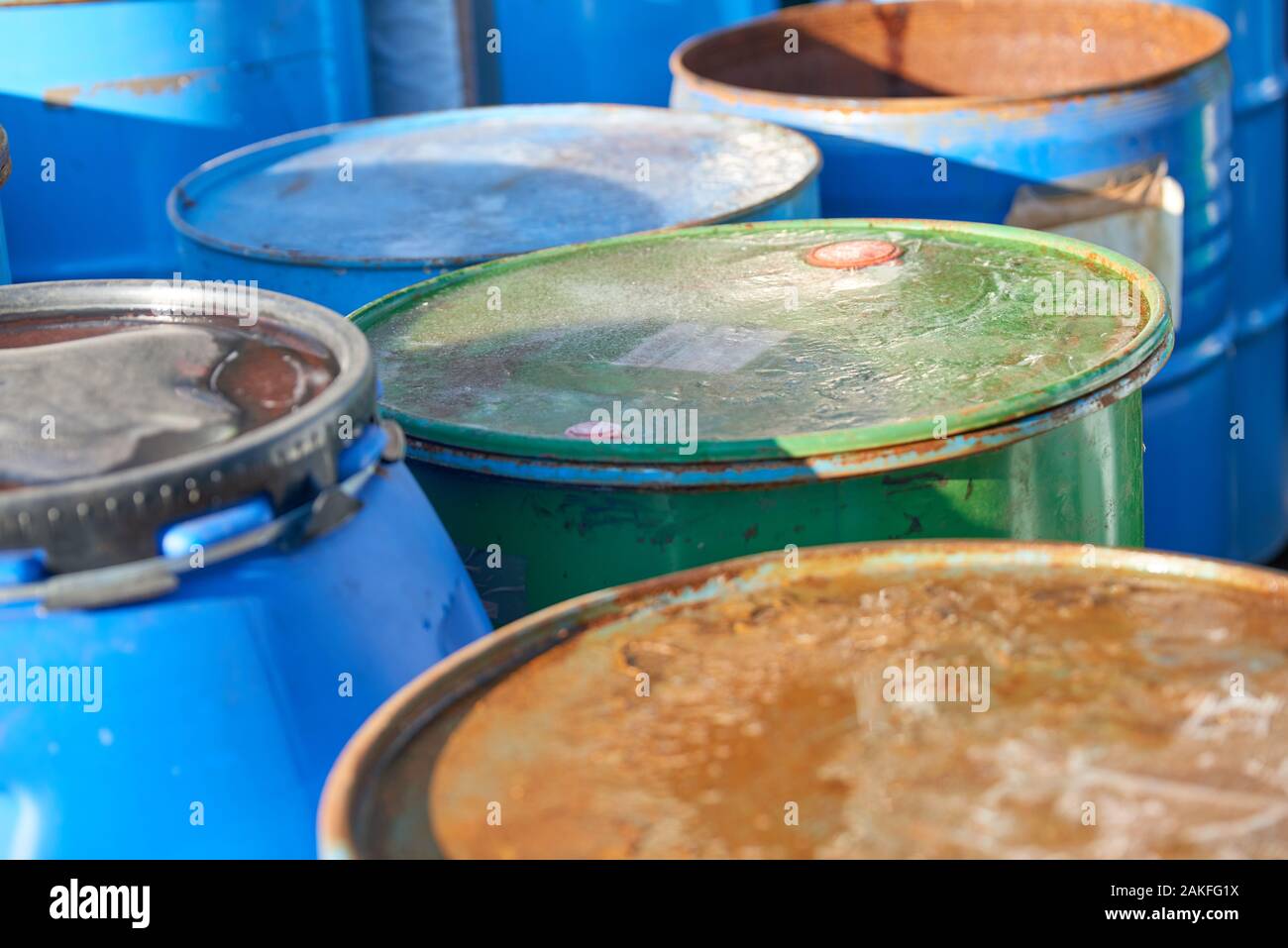 Recycling industry - Rusty metal barrels stacked in rows, toxic waste ...