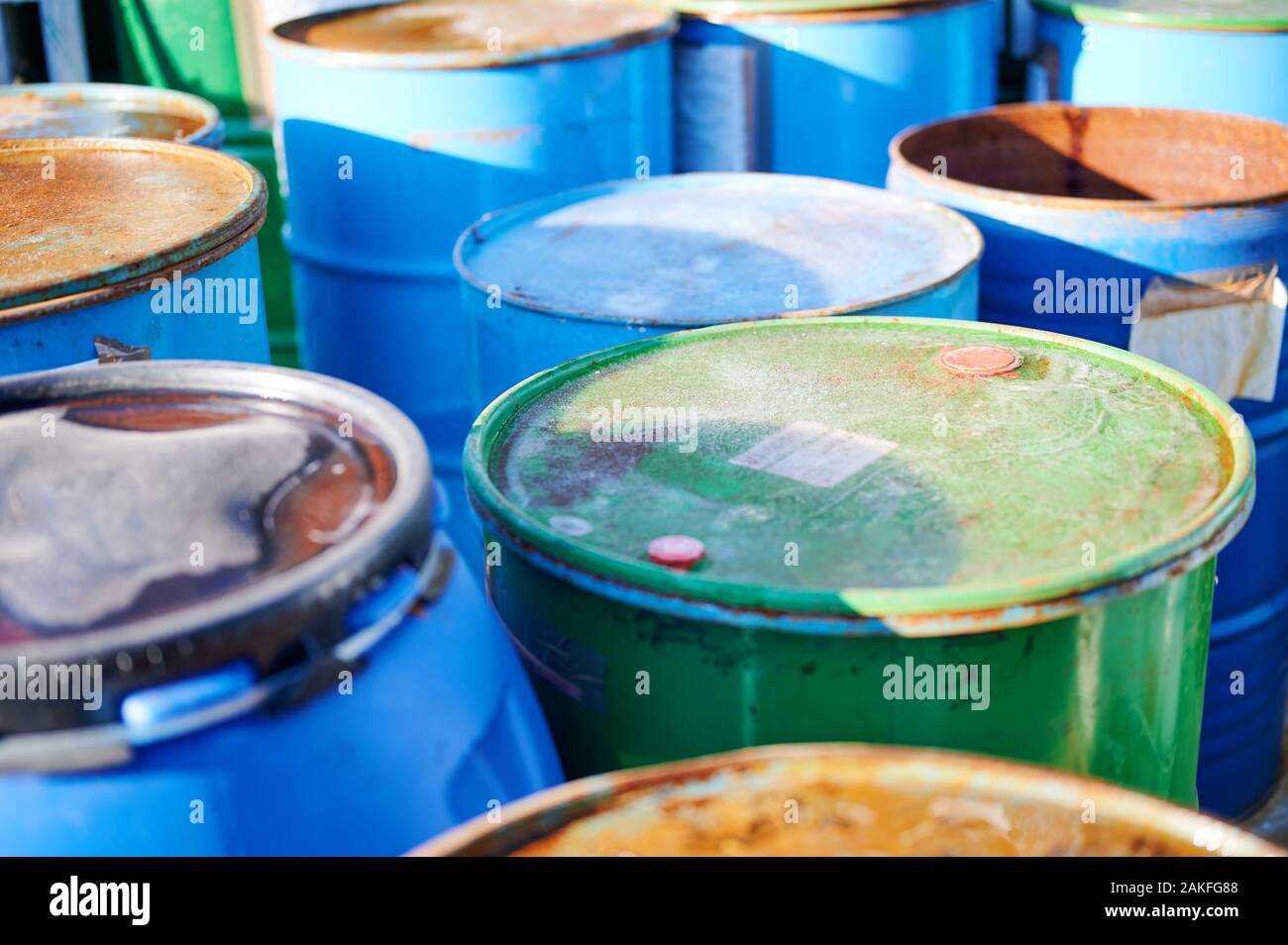 Recycling industry - Rusty metal barrels stacked in rows, toxic waste ...