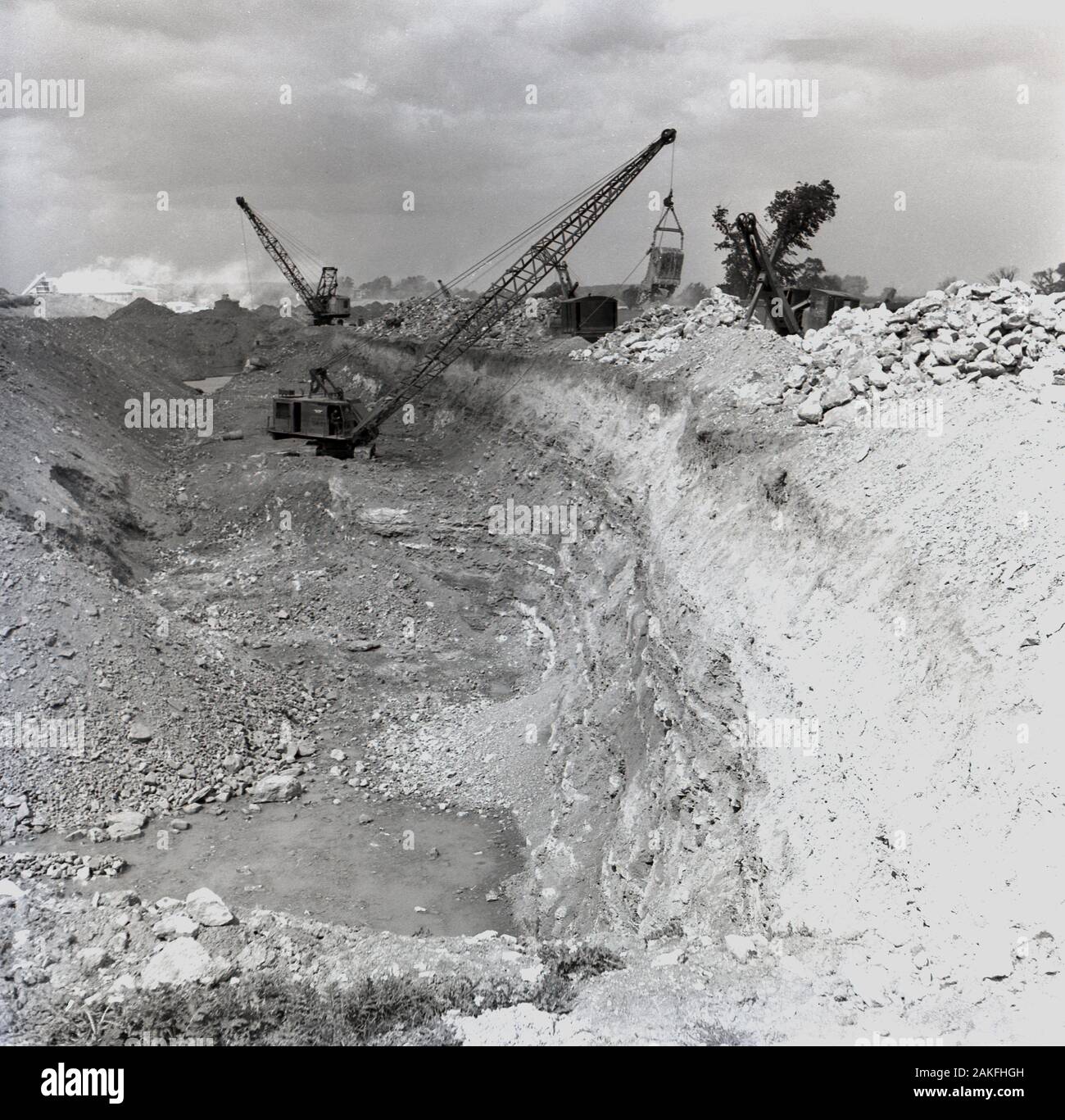 1950s, historical, a crane in large open pit or quarry, England, UK ...