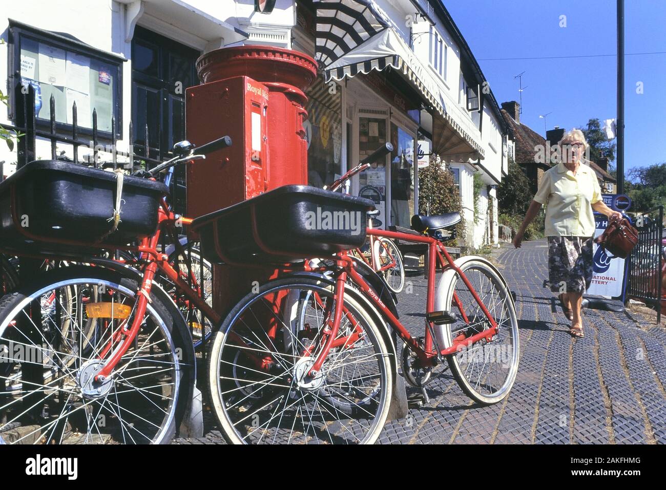 Royal Mail postal bikes leaning against a postbox, Sutton Valence, Kent ...