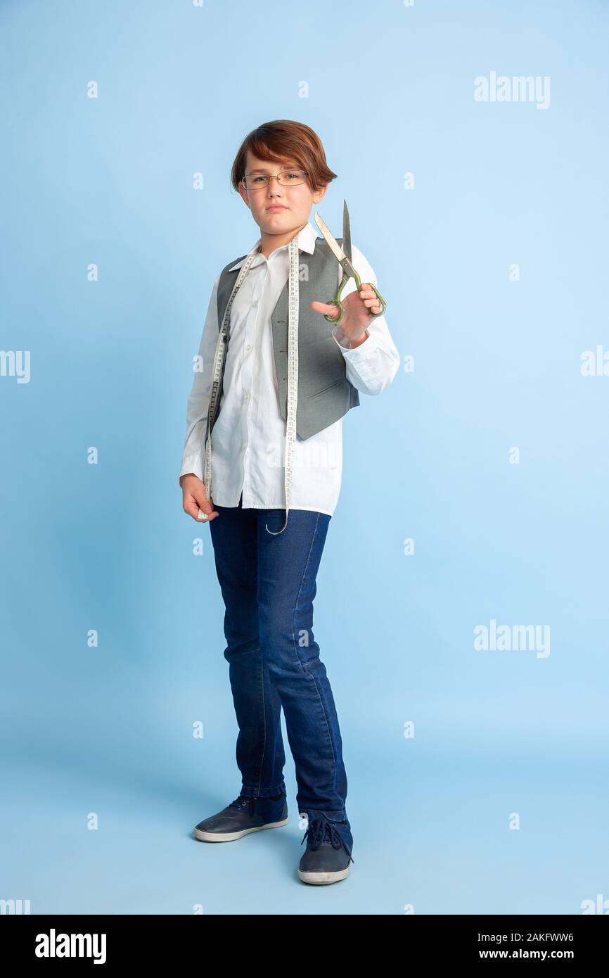 Little boy dreaming about future profession of seamstress. Childhood ...