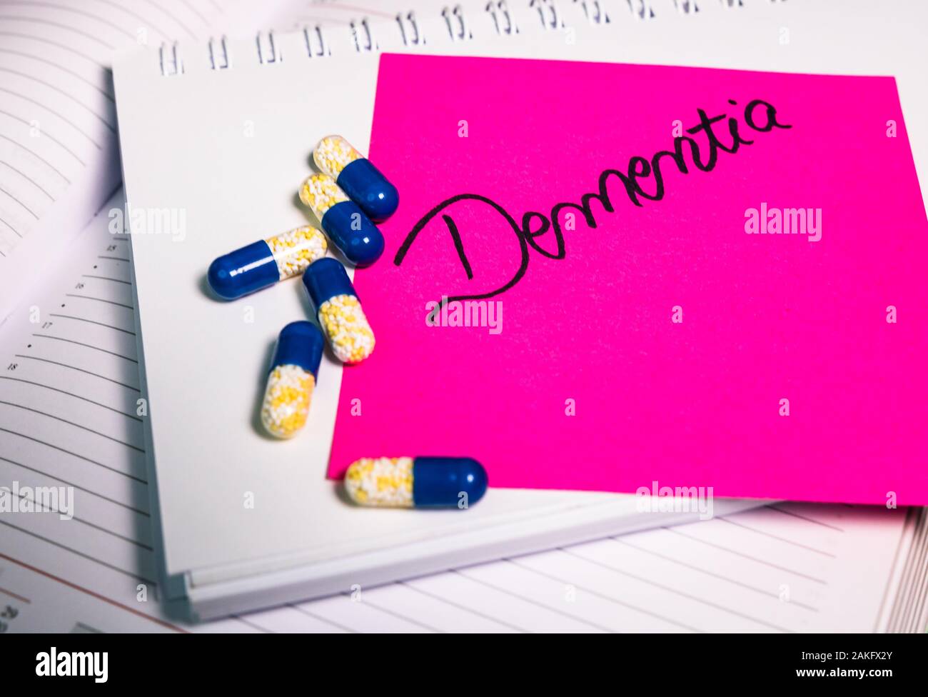 Writing Dementia on memo post reminder and medicines, pills. Writing ...
