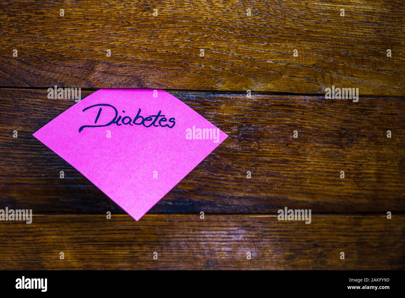 Writing Diabetes on memo post reminder. Text Diabetes on sticky paper ...