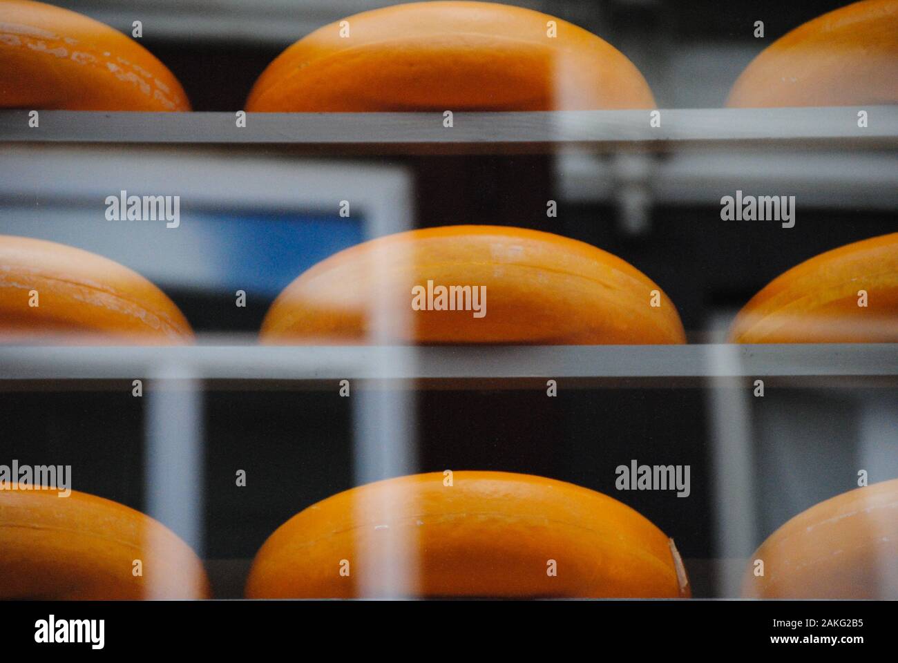 Cheese forms in shop window Stock Photo - Alamy